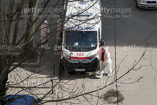 Doctor adjusts his personal protective suit while walking out of first ...