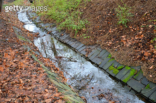 stream to cobbled into a narrow channel. the upper side is planted with ...