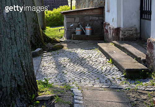 stone granite staircase, water tank by the cemetery wall. The inflow ...