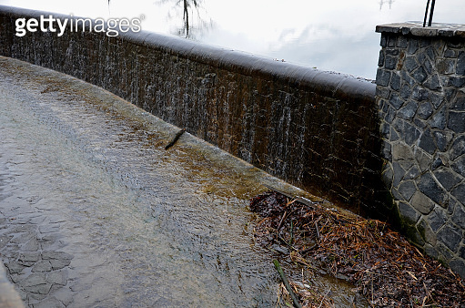 bridge over safety spillway of the dam. stone bridge with natural ...