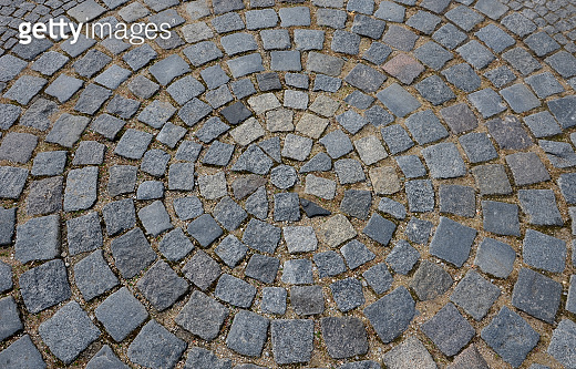 square with a large dark gray circle inside a small round of ...