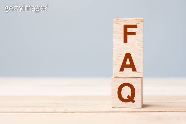 wooden cube blocks with FAQ text (frequently asked questions) on table ...
