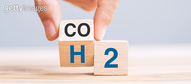 hand flipping wooden cube blocks with CO2 (Carbon dioxide), change to ...