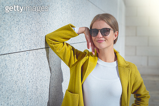 young elegant woman with sunglasses posing, beautiful and cute ...