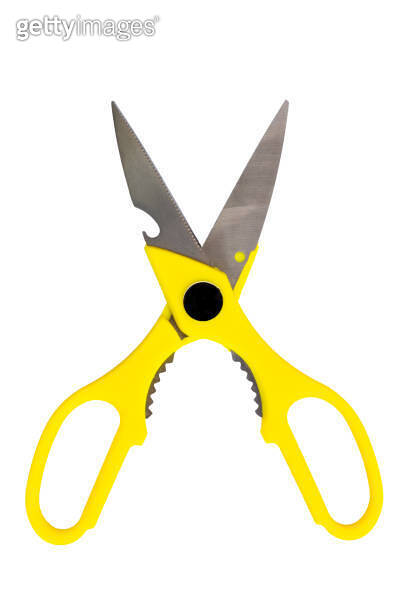 Cutlery scissors with yellow handles for cutting on a white background ...