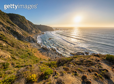 An awe sunset in an idyllic beach landscape with the sunset over the ...