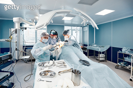 A modern operating room, surgeons and doctors doing an oncological ...