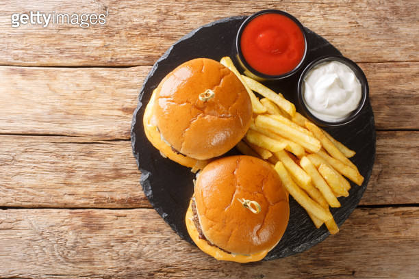 American butter burgers with beef, onions and cheese served with fries ...