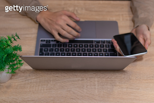 top view of hands with computer and mobile phone on desk 이미지 ...