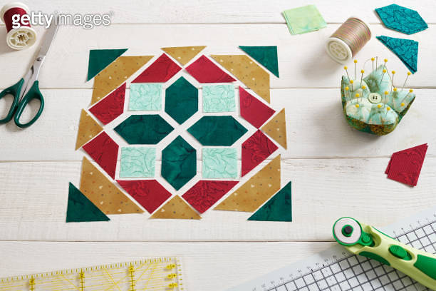 Pieces of fabric laid out in the shape of a patchwork block, sewing and ...