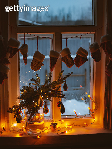 Christmas rustic old window at night with decorated spruce branches in ...