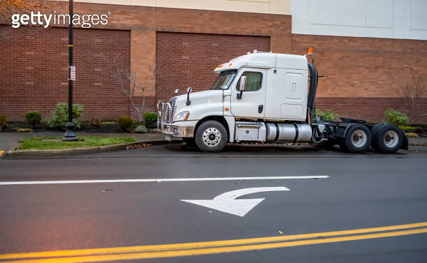 White big rig powerful semi truck with low cabin and grille guard ...