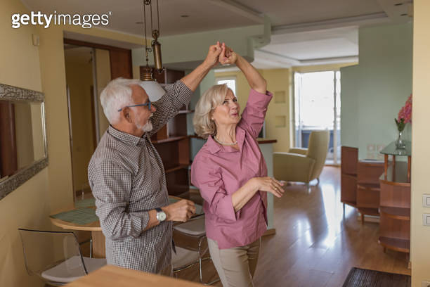 Cheerful Couple of Retirees is Dancing at Home with lot of Lovely ...