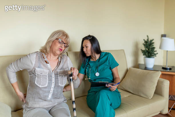 An Older Sick Woman is Receiving a Medical Care from a Young Female ...