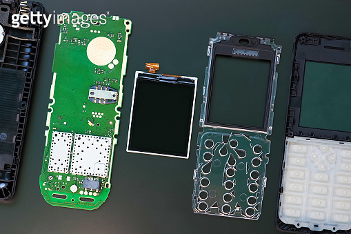 Disassembled push-button mobile phone. Details of telephone top view ...