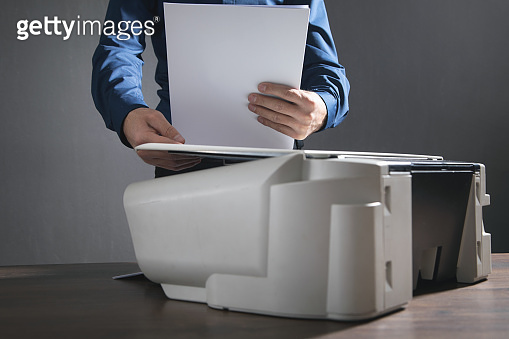 Man copying and scanning documents in office. (1359707564) - 게티이미지뱅크