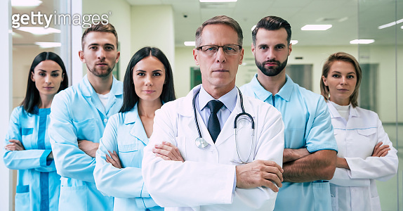 Group of successful and confident modern medical doctors are posing and ...