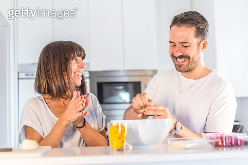 A Caucasian couple cooking together at home, cooking in confinement ...