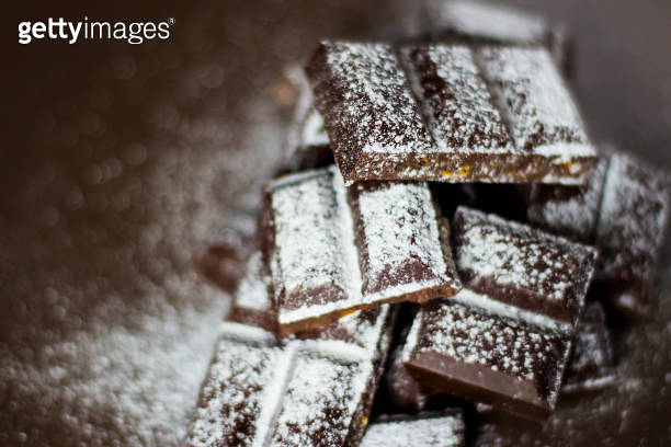 Dark chocolate in powdered sugar. Chunks of dark chocolate. (1306297983 ...