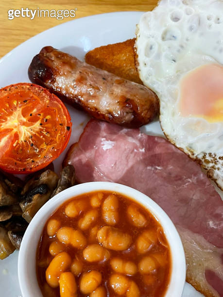 Close-up image of full English fried breakfast of bacon rasher, grilled ...