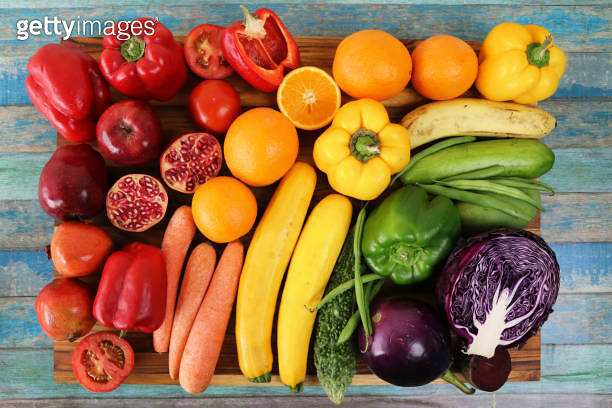 Close-up image of rainbow display of multi-coloured fruit and ...
