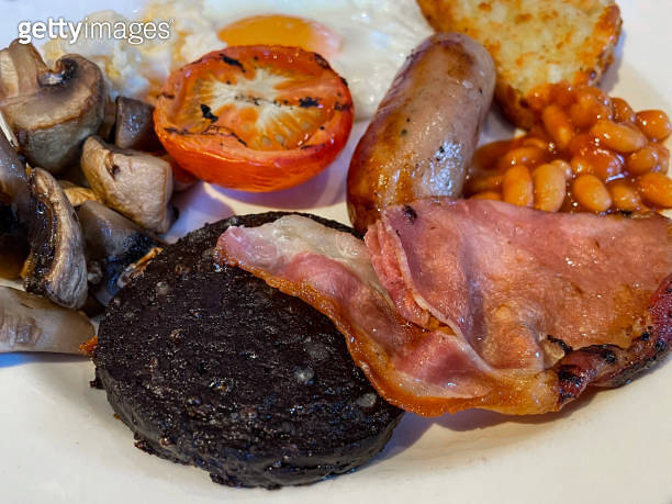 Full frame image of full-English fried breakfast of bacon rasher ...