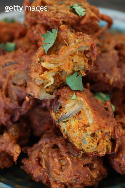 Full frame image of pile of homemade crispy onion bhajis / pakoras ...
