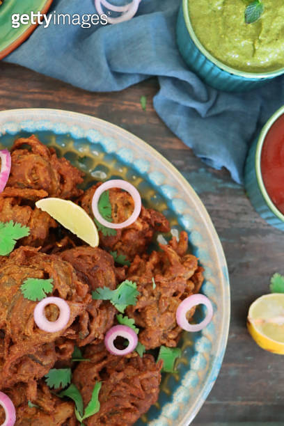Close-up image of pile of homemade crispy onion bhajis / pakoras ...