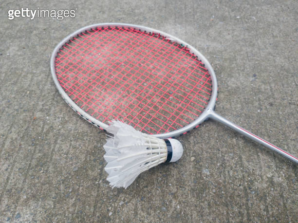 badminton racket and shuttlecock, playing badminton in an open field ...