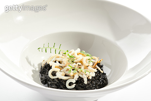 Risotto with cuttlefish black ink. Black risotto plate isolated on ...