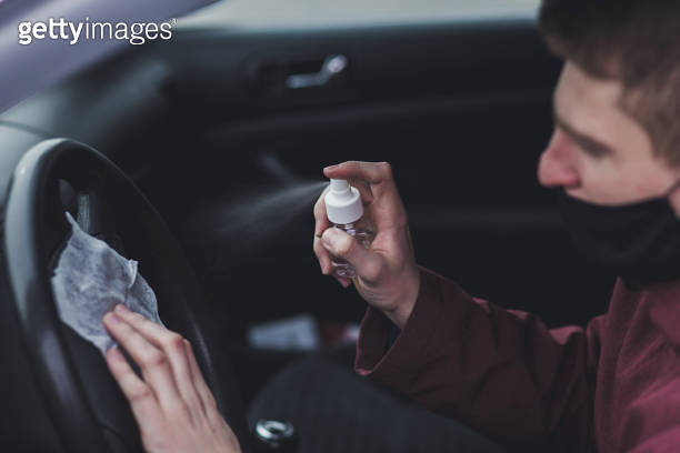 Man spraying anti-bacterial sanitizer spray 이미지 (1298572996) - 게티이미지뱅크