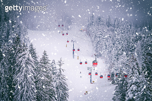 Postavaru mountain with ski slopes and cable car transporting ...