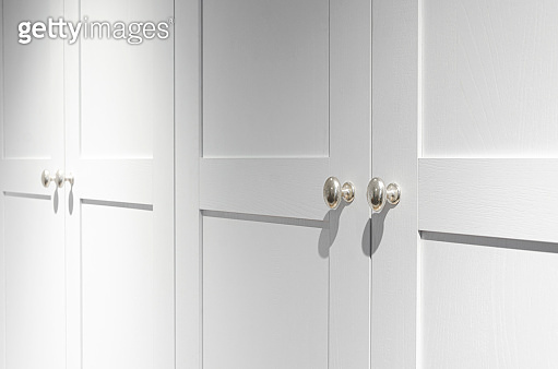Furniture fittings. Metallic silver door handles with sharp shadows on ...