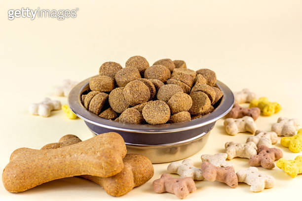 Brown biscuit bones and crunchy organic kibble pieces for dog feed on ...