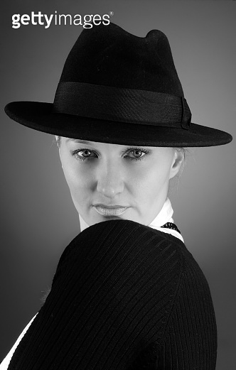 Serious woman in a black hat posing as a secret agent 이미지 (1321011414 ...