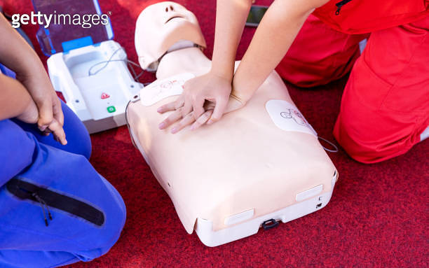 First aid and CPR class using automated external defibrillator device ...