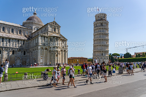 Crowd of tourists visit Leaning Tower of Pisa in summer time in Italy ...