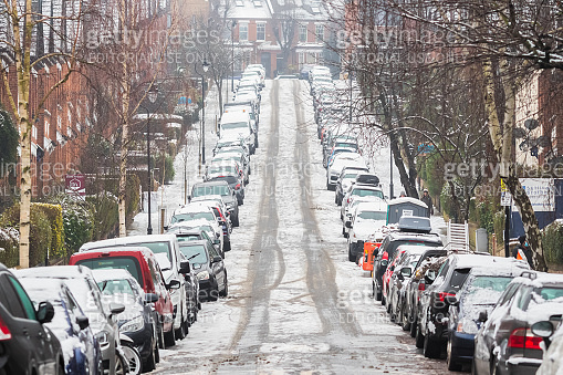 Long terraced street covered by snow in Crouch End area, London ...
