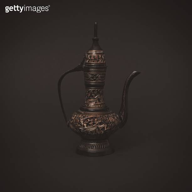 Vintage traditional islamic oriental engraved pitcher handmade on dark ...