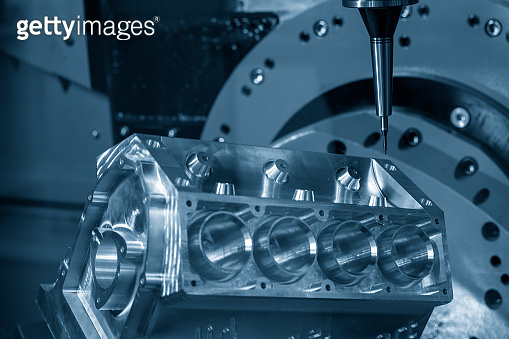 The 5-axis machining center cutting the v8-engine cylinder block. The 5 ...