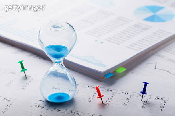 Best time for investment. Hourglass, financial charts, calculator and ...