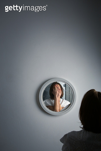 Reflection of a woman's face in broken mirror. Depression, anxiety ...