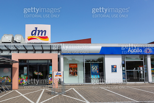 facade and entrance of a dm store and an Apollo store. dm is a German ...
