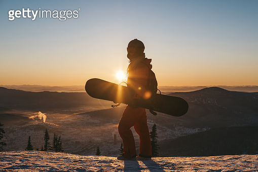 Female with snowboard. Snowboarder standing and resting in winter ...