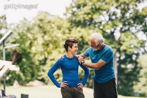 Grandfather is supporting his grandson to continue working out. 이미지 ...