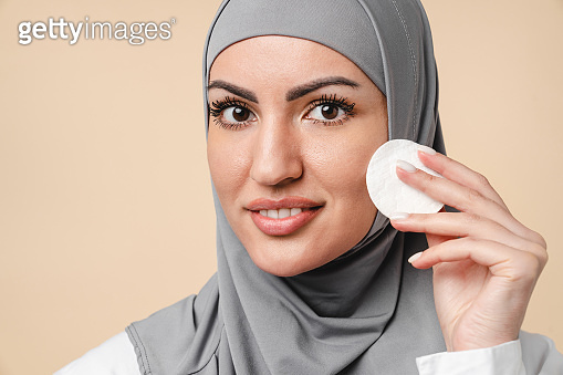 Muslim arabian islamic young beautiful woman in grey hijab holding ...