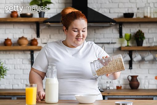Hungry starving caucasian woman cooking healthy dieting breakfast ...