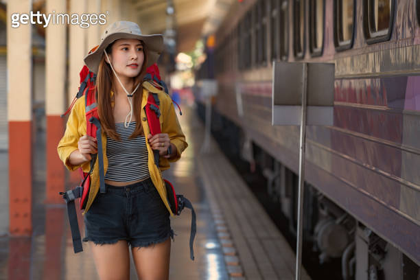 Portrait of young female backpacker smiling when arriving at her ...