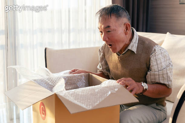 Happy old senior customer receive post shipment and unboxing at home ...