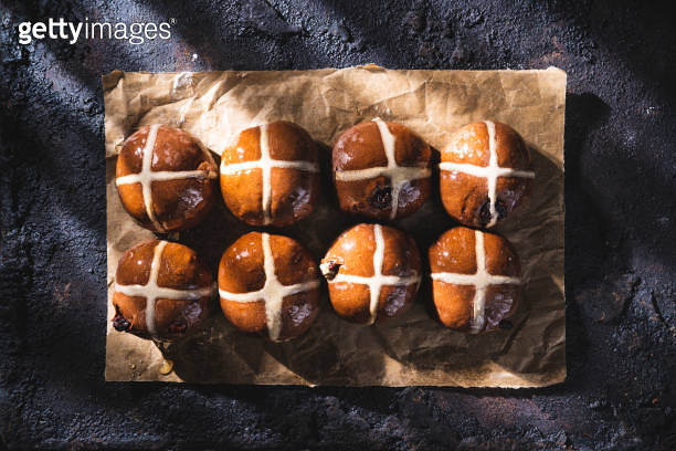 Homemade Easter Hot cross buns just fresh baked over baking paper on ...